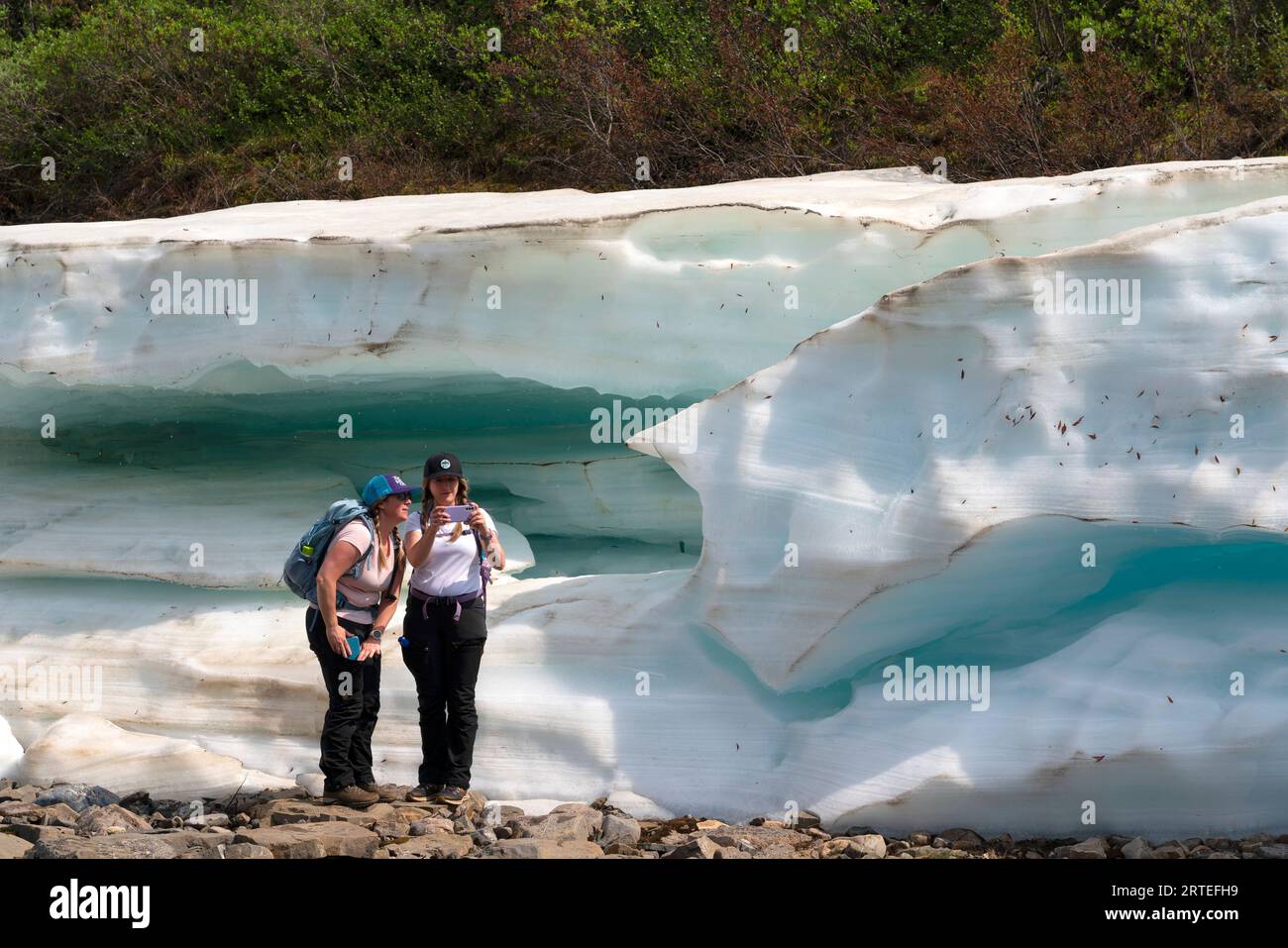 Close-up of two woman exploring and taking a selfie standing next to ...