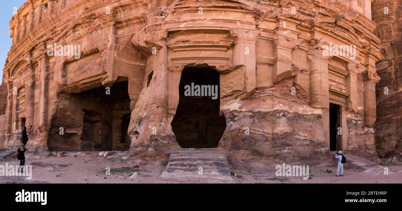 Tourists photograph the ruins of one of the many tombs in Petra; Petra ...