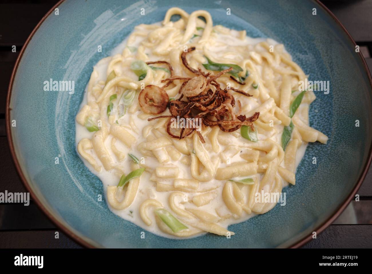 Top view, Cheese Spaetzle, Käsespätzle. with mushroom, cream sauce and ...