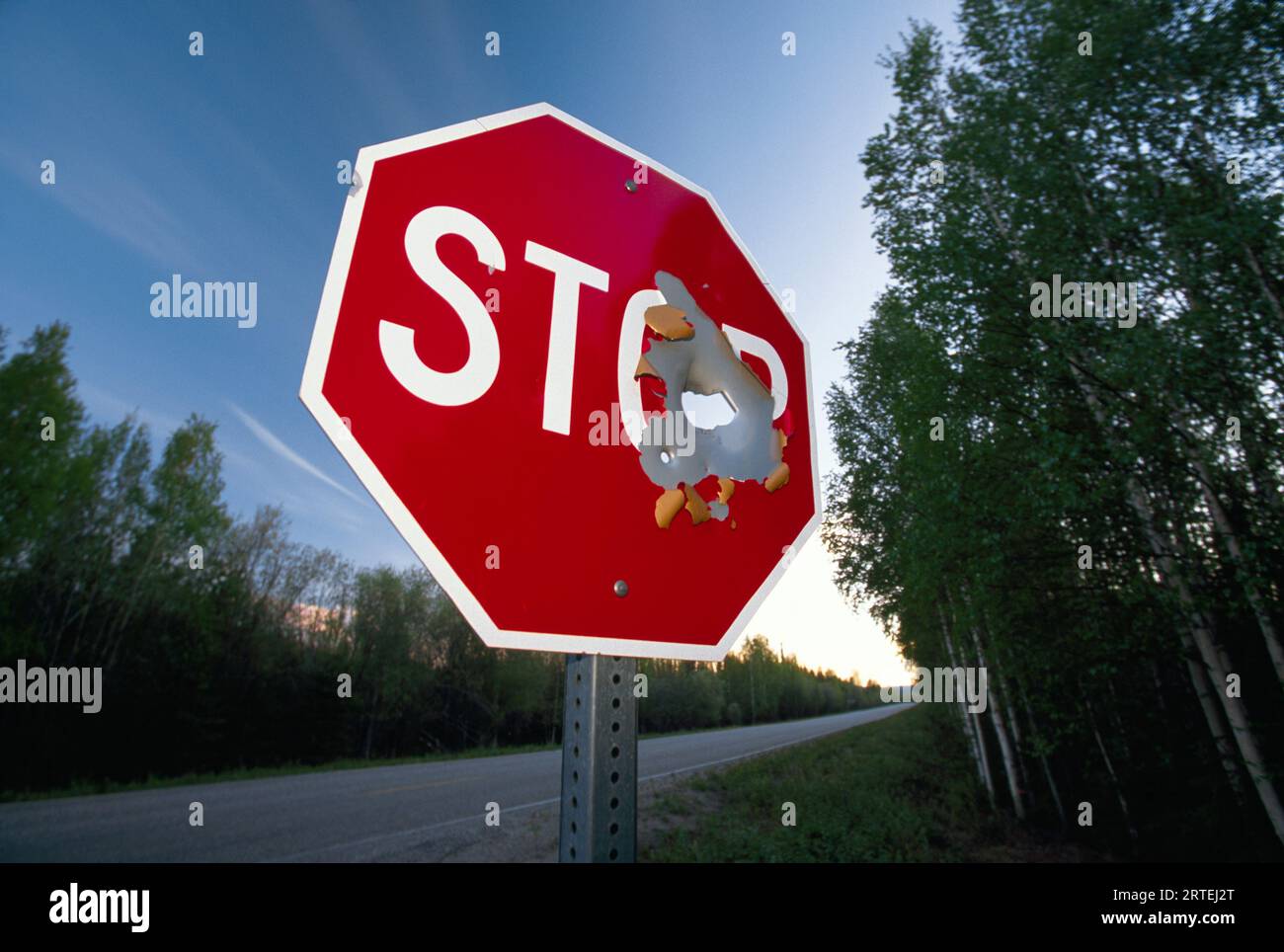 Stop sign with a large bullet hole; Fairbanks, Alaska, United States of ...
