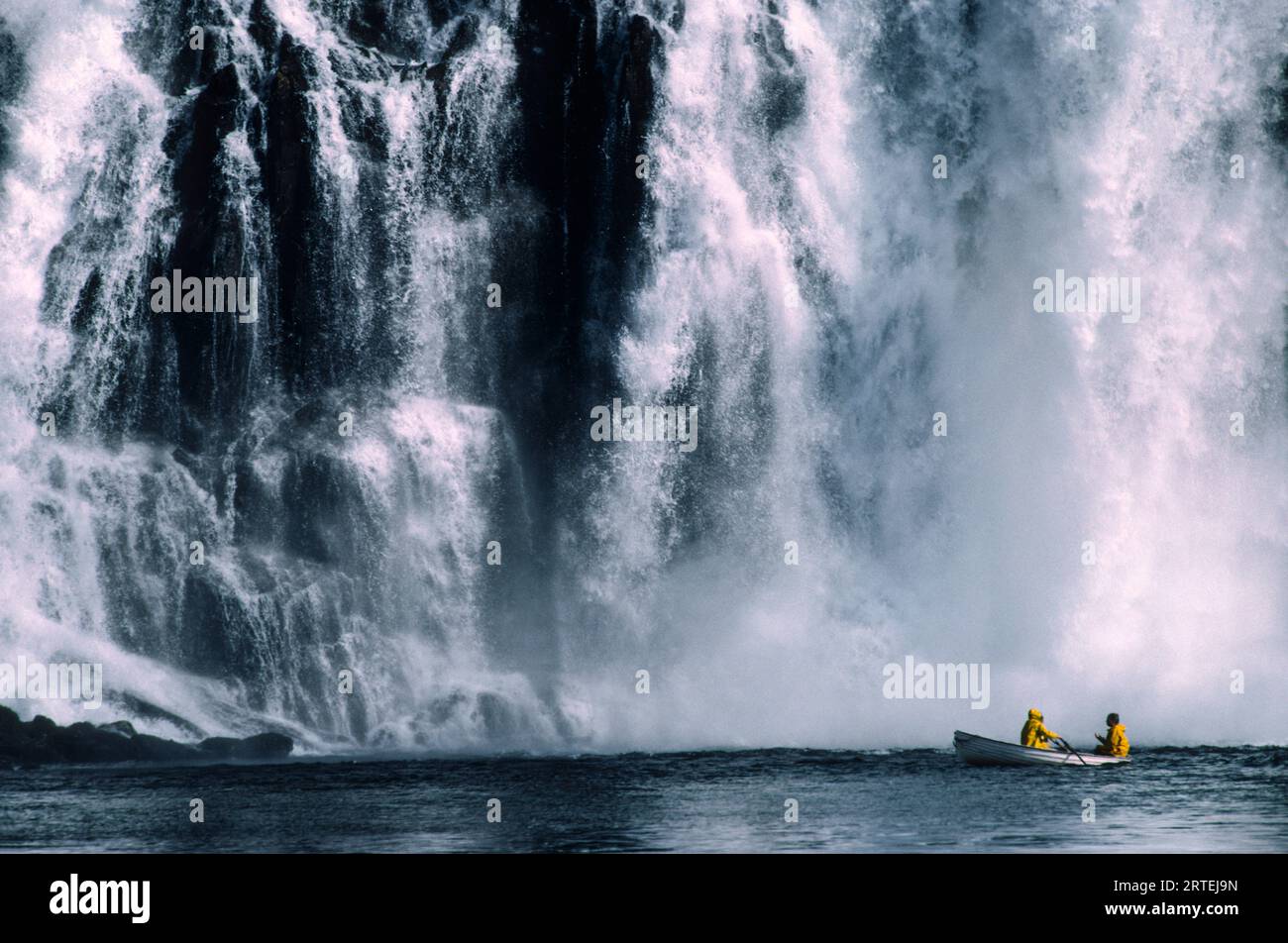 Boat under a waterfall in the Prince William Sound, Alaska, USA; Alaska ...