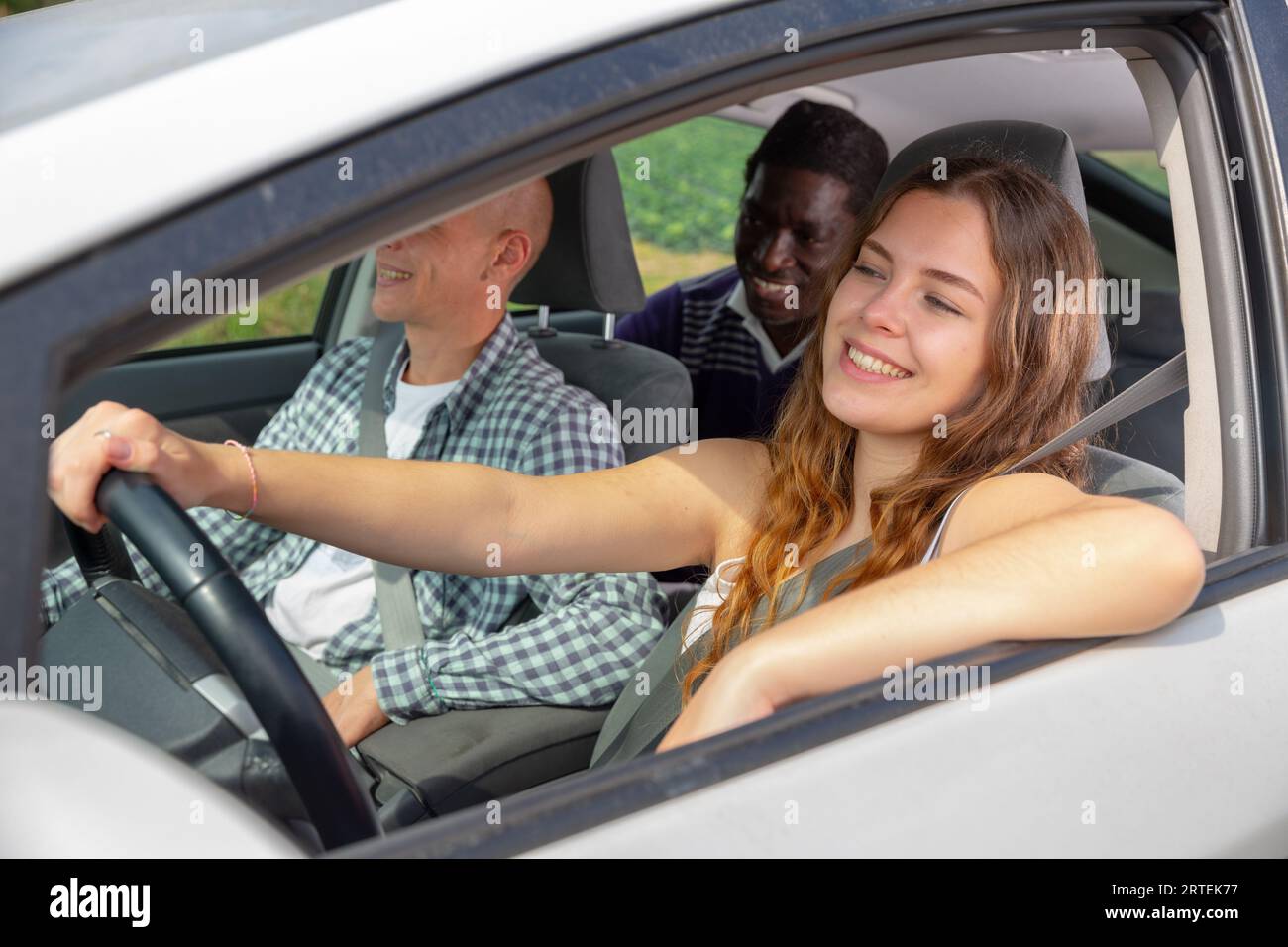 Happy friends driving in the car with open windows Stock Photo - Alamy
