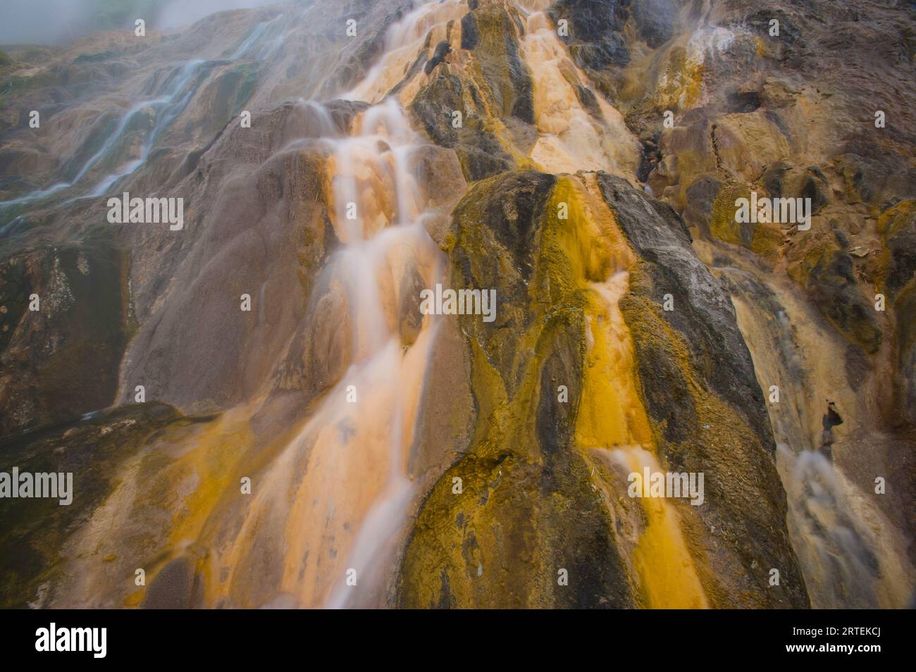 Hot water from geysers pours down rocks in the Valley of Geysers ...