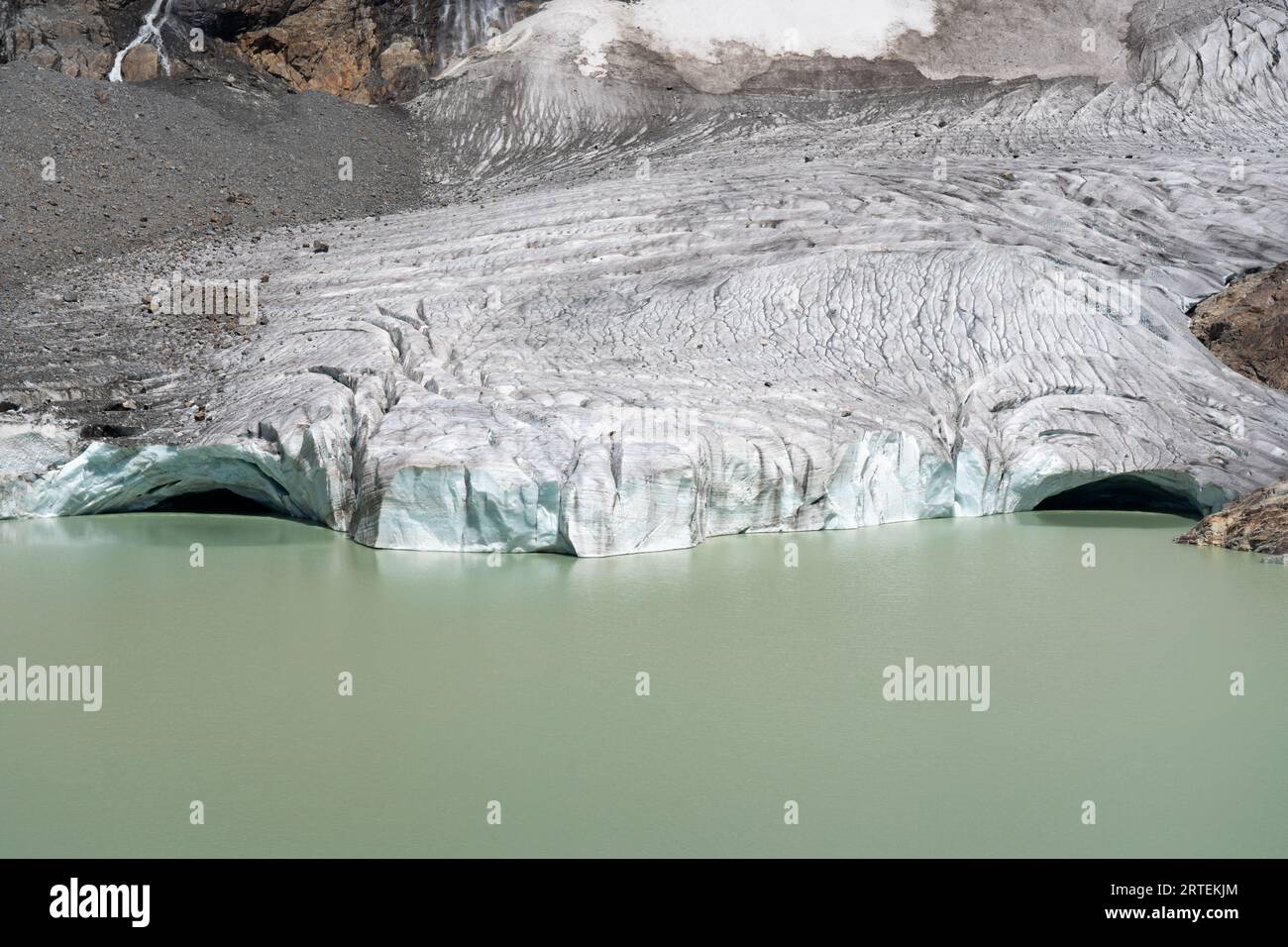 Mountain glacier melting into the lake. ice crevasses and caves. Global ...
