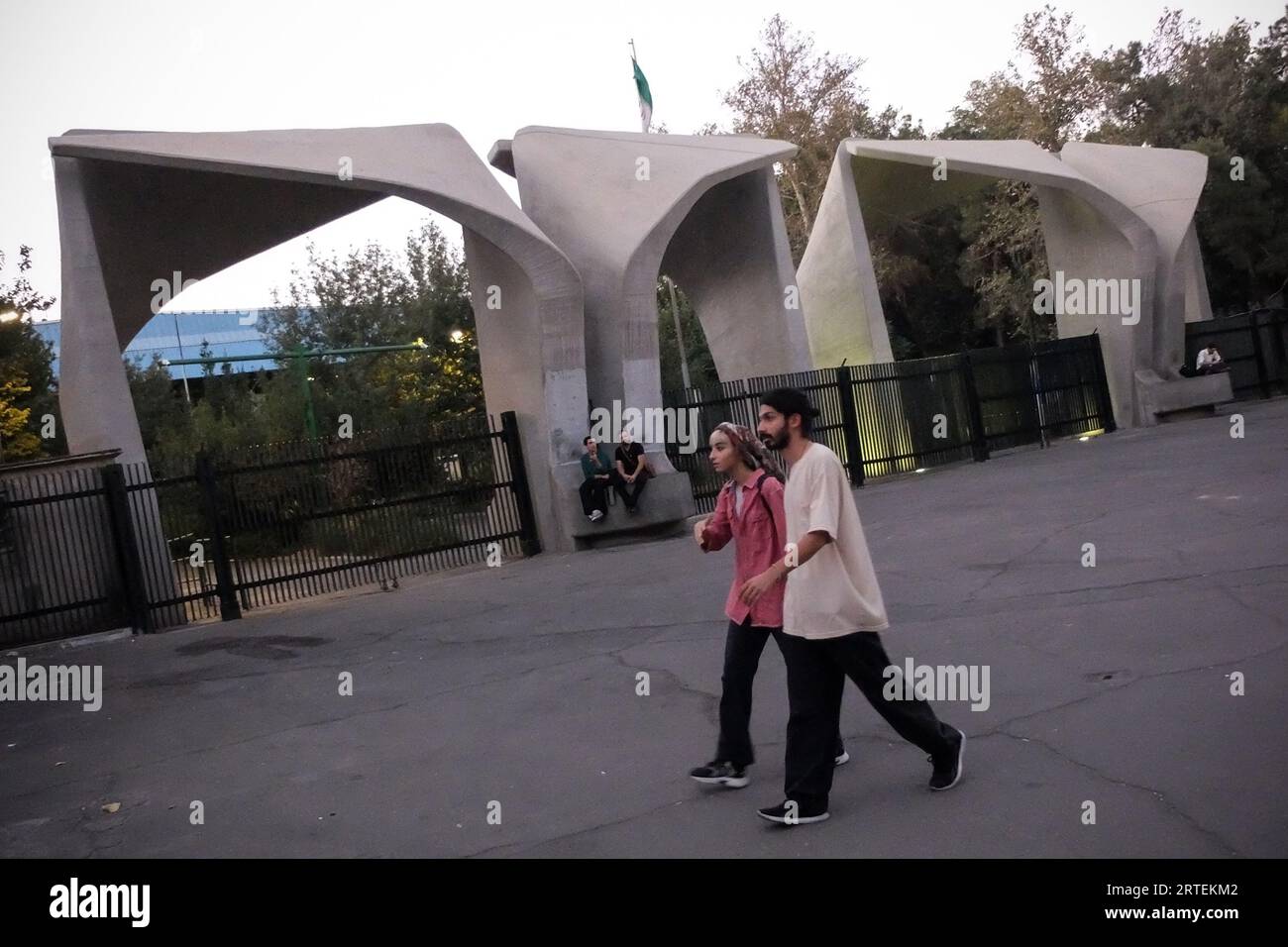 Tehran, Iran. 12th Sep, 2023. An Iranian couple walks in front of the ...