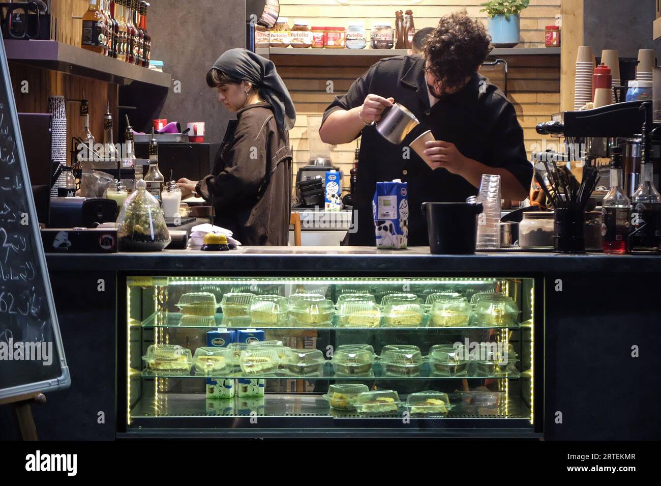 Tehran, Iran. 12th Sep, 2023. An Iranian man prepares coffee in a small ...