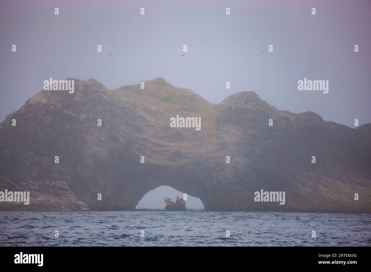 Ecotourists explore Bear Island in an inflatable raft; Bjornoya or Bear ...