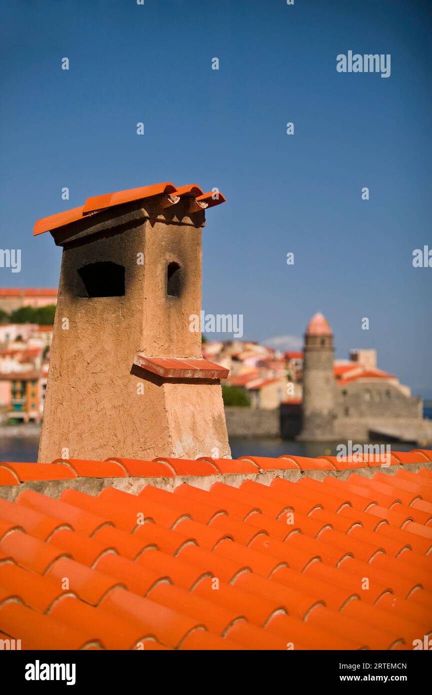 Ceramic tile roof and chimney on a house on the coast of France; French ...