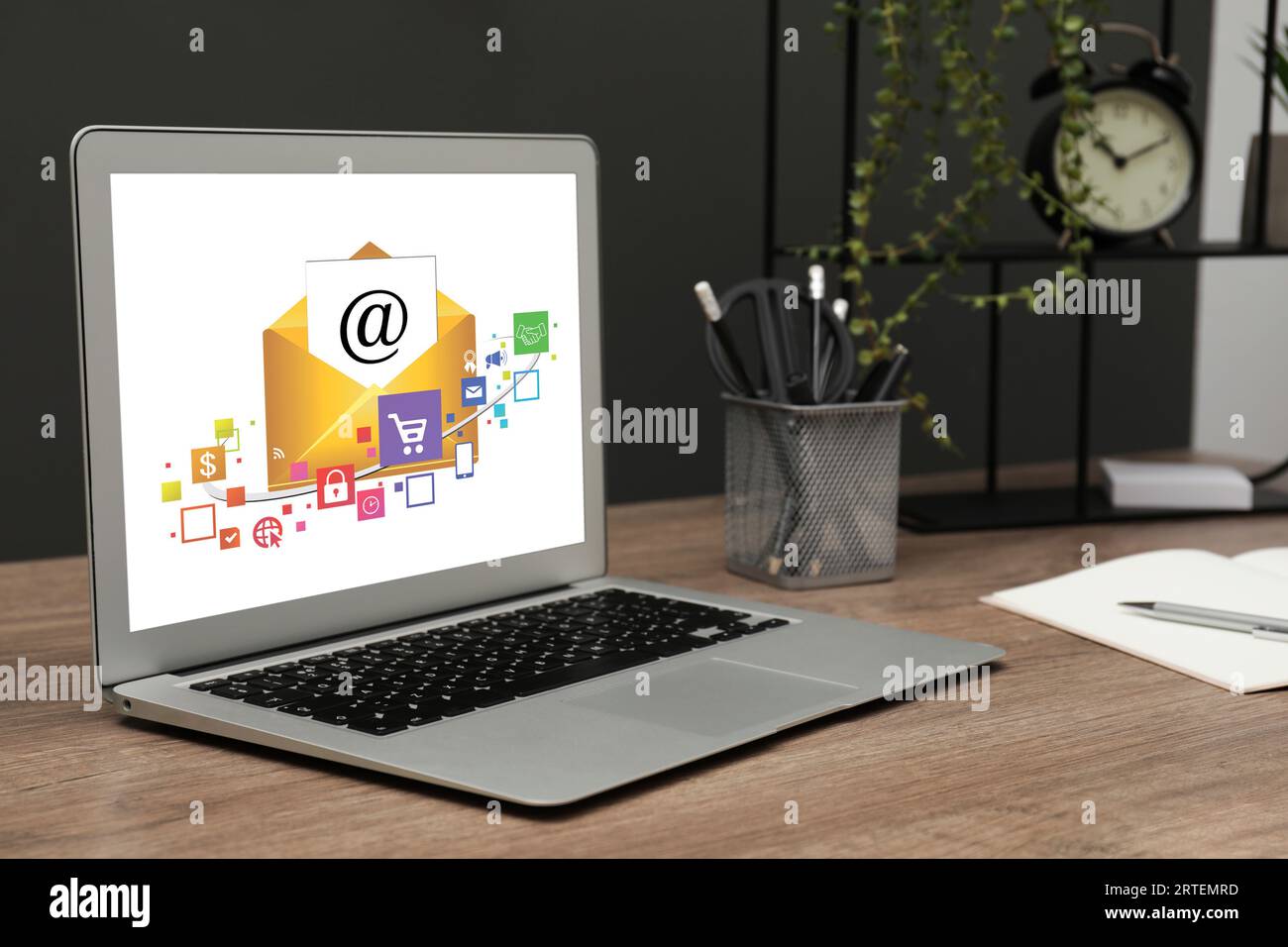 Email marketing. Laptop with icons on screen in office Stock Photo - Alamy