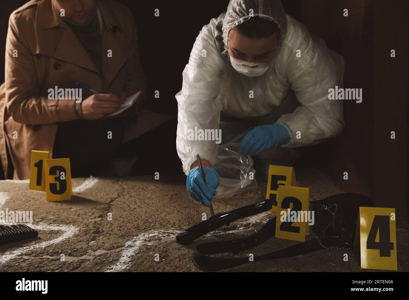 Investigator and criminologist working at crime scene outdoors in evening Stock Photo - Alamy