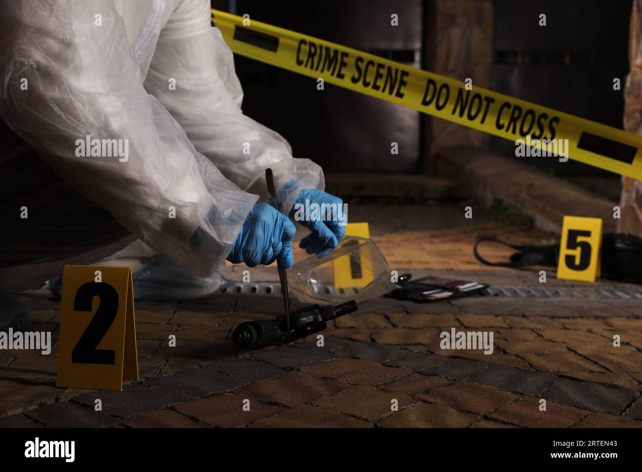 Criminologist in gloves working with evidences at crime scene outdoors, closeup Stock Photo - Alamy