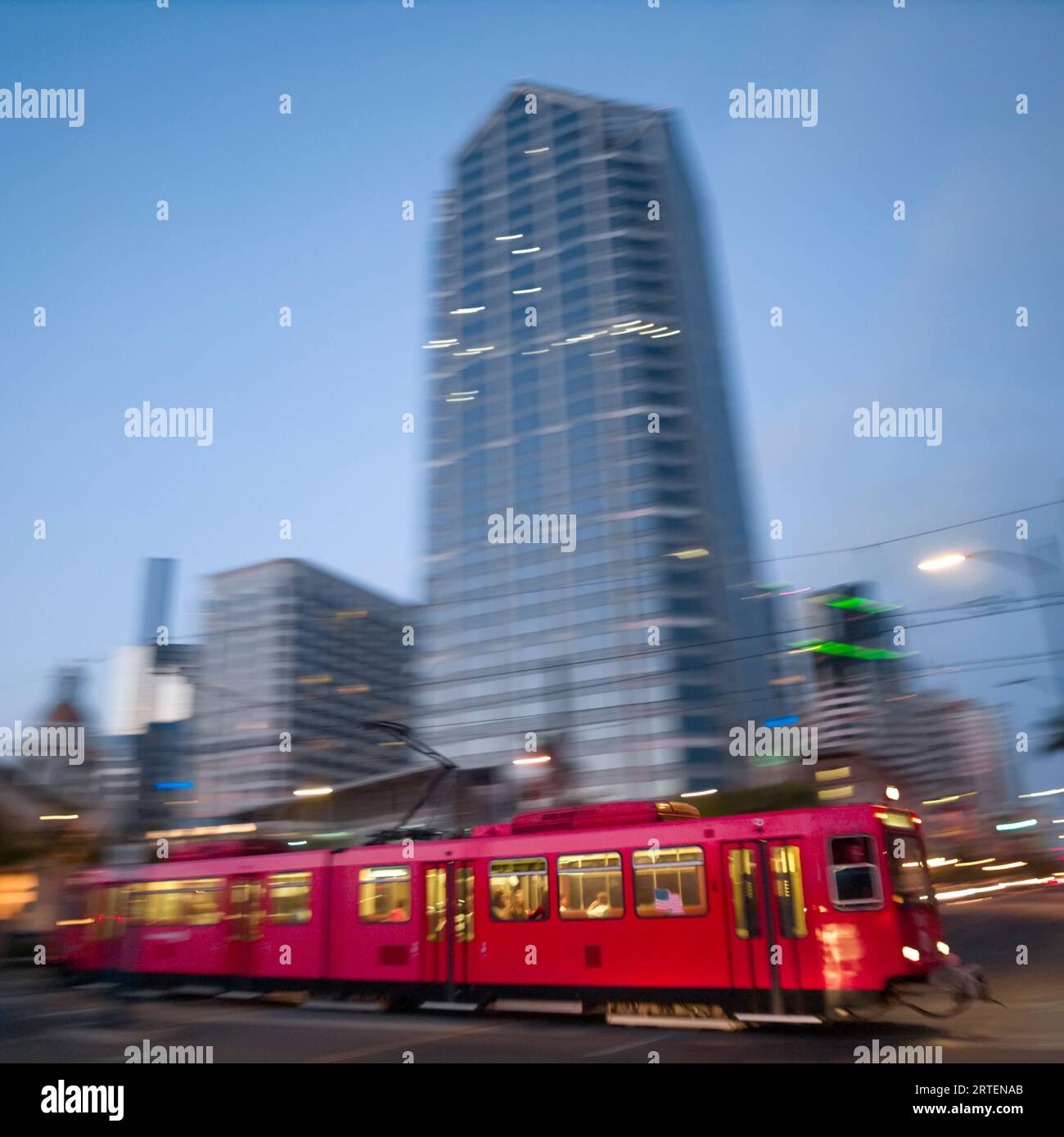Trolley traveling through San Diego at the foot of Broadway at dusk ...