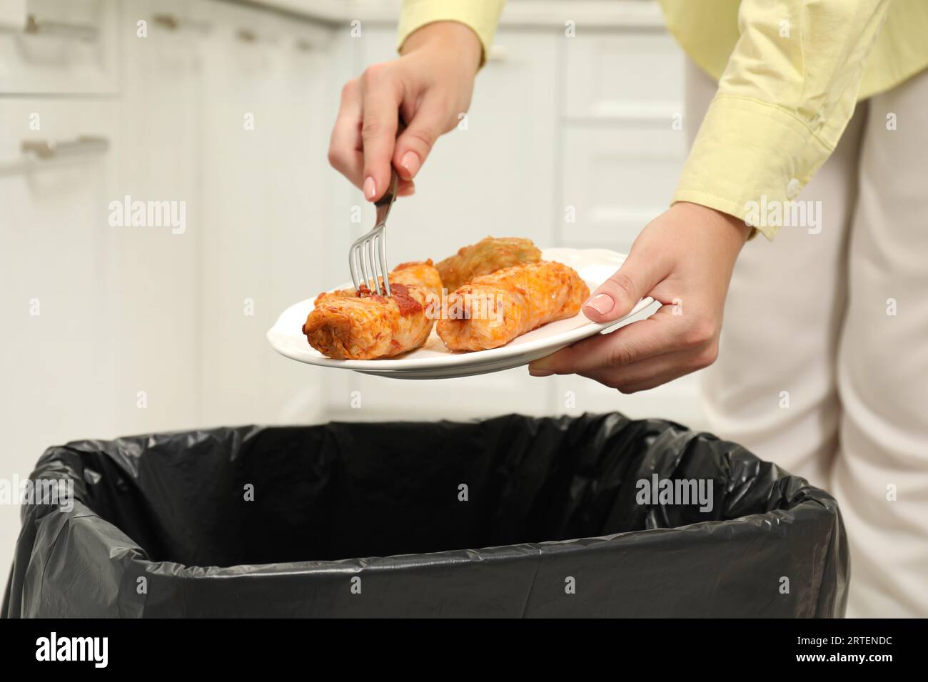Woman throwing plate of food bin hi-res stock photography and images ...