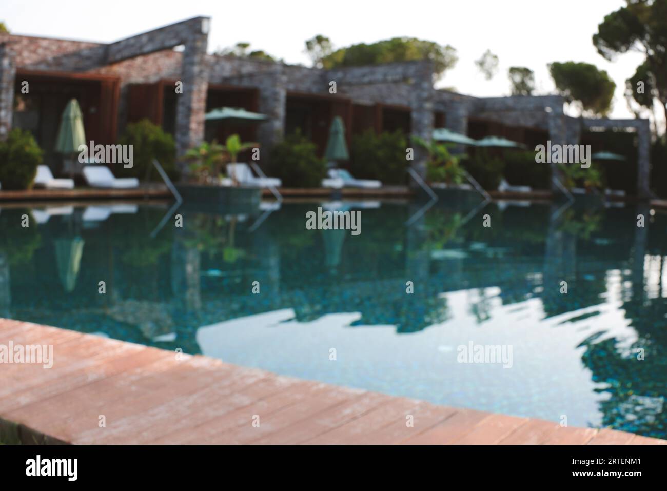 Outdoor swimming pool at resort, blurred view Stock Photo - Alamy
