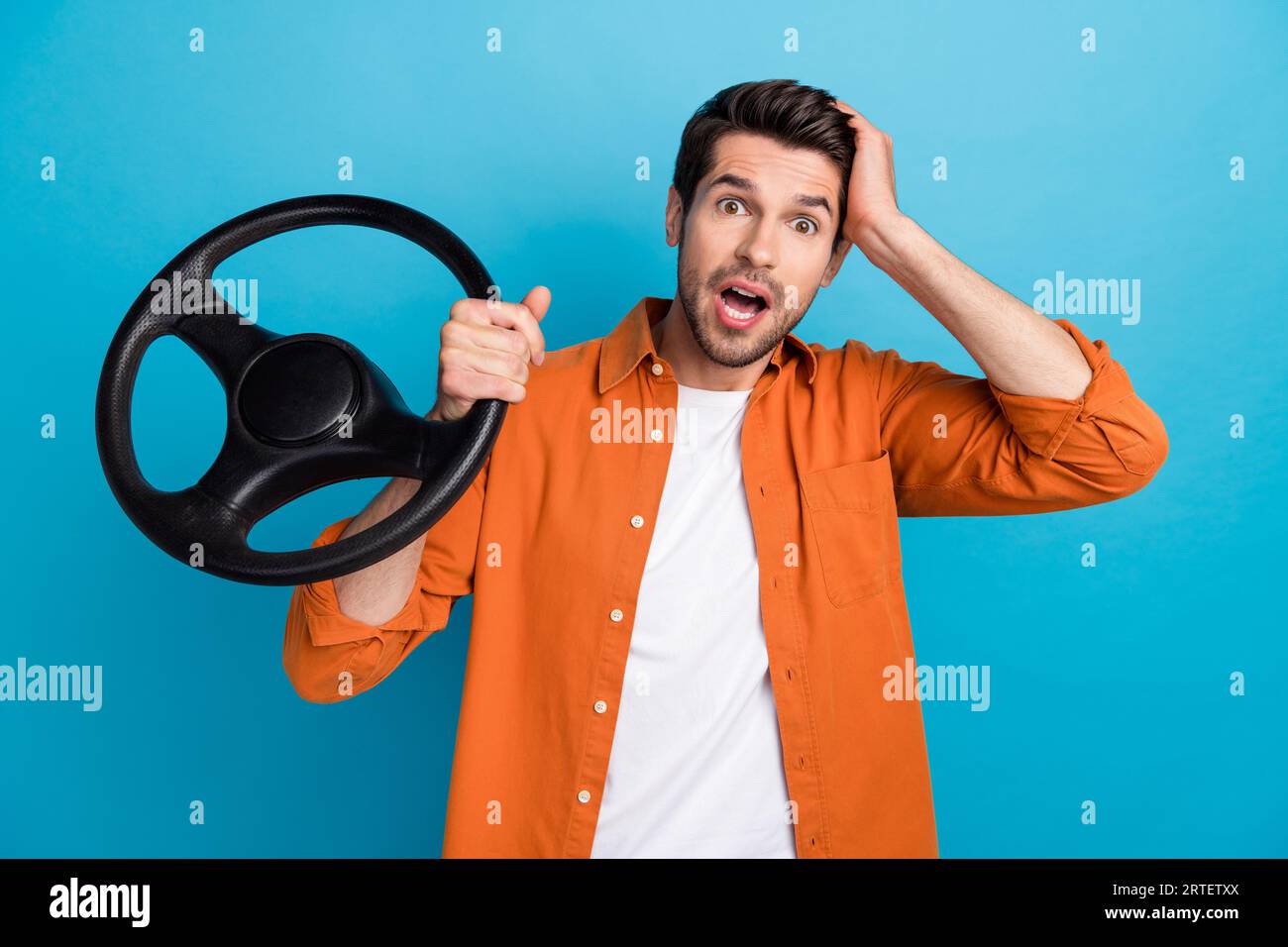 Photo of impressed confused speechless person arm touch head hold wheel ...