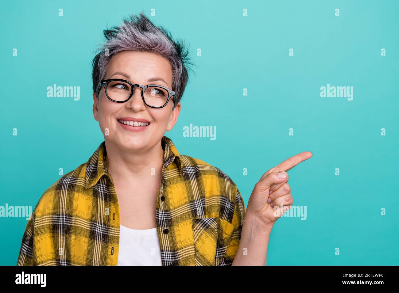 Portrait of charming middle age lady direct finger empty space ad ads ...