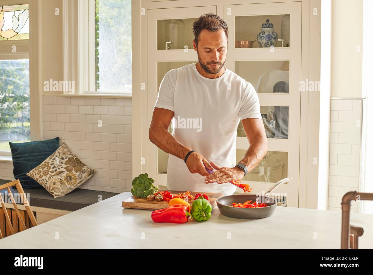 Man cutting vegetables in kitchen Stock Photo - Alamy
