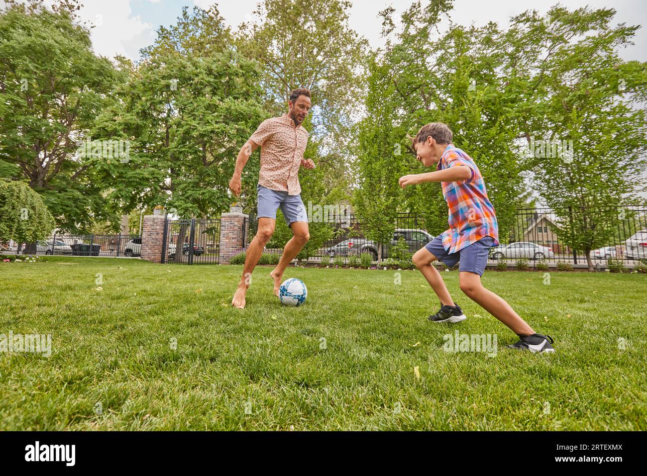 Boys playing soccer barefoot hi-res stock photography and images - Alamy
