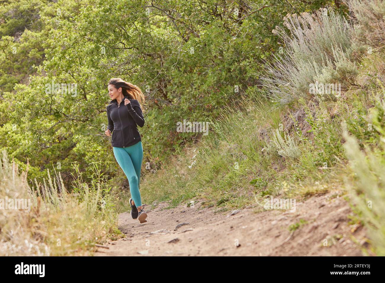 Mid adult woman jogging outdoors Stock Photo - Alamy