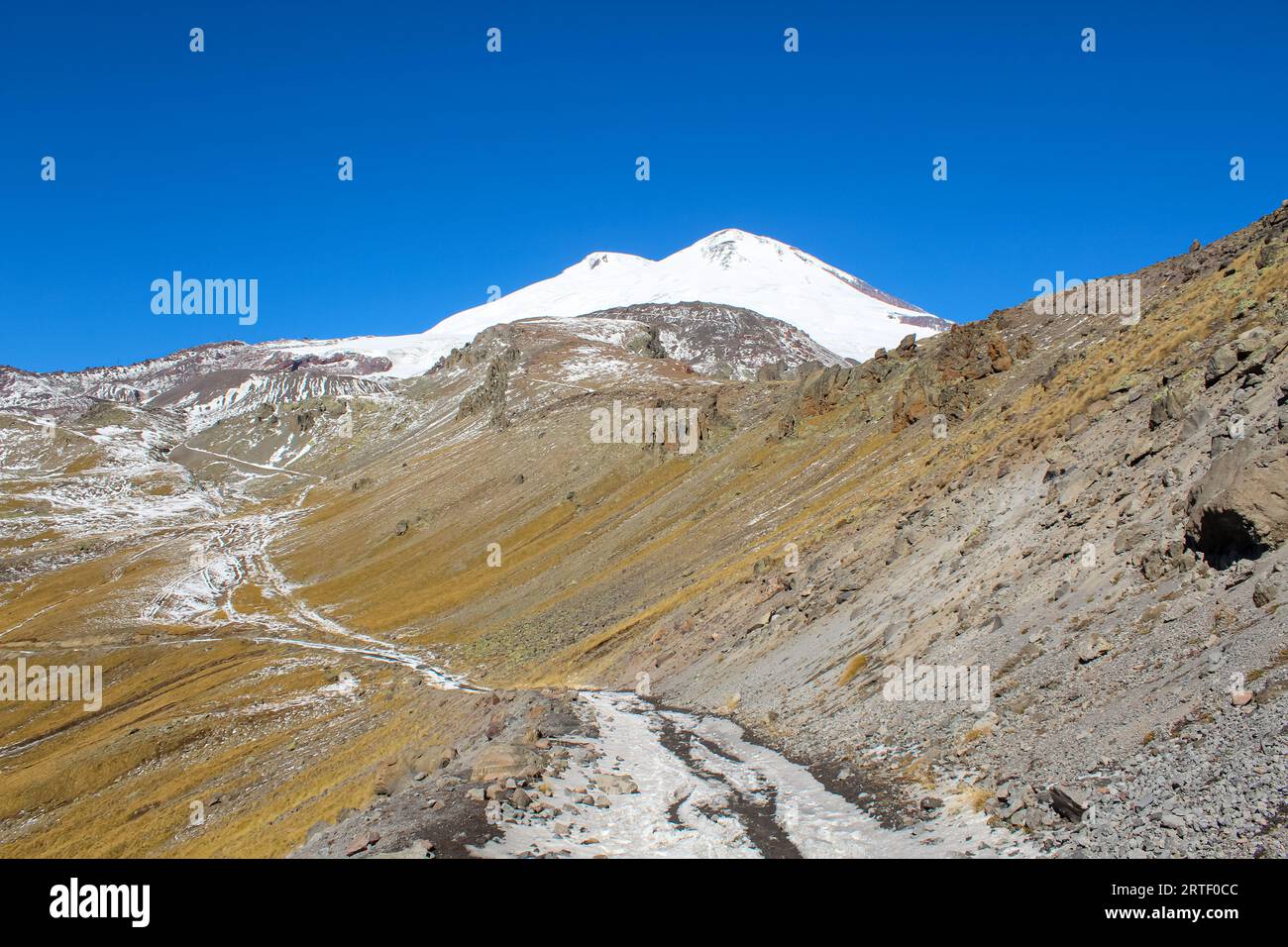 Double peak of Mount Elbrus, the highest mountain in Europe, blue sky ...
