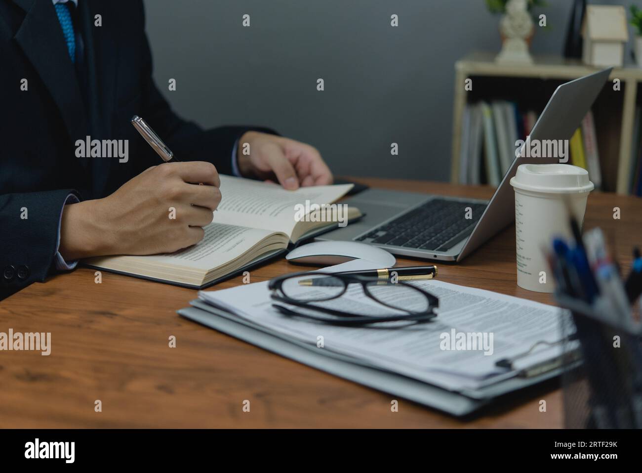 learning online class by using laptop computer and writing notebook at ...