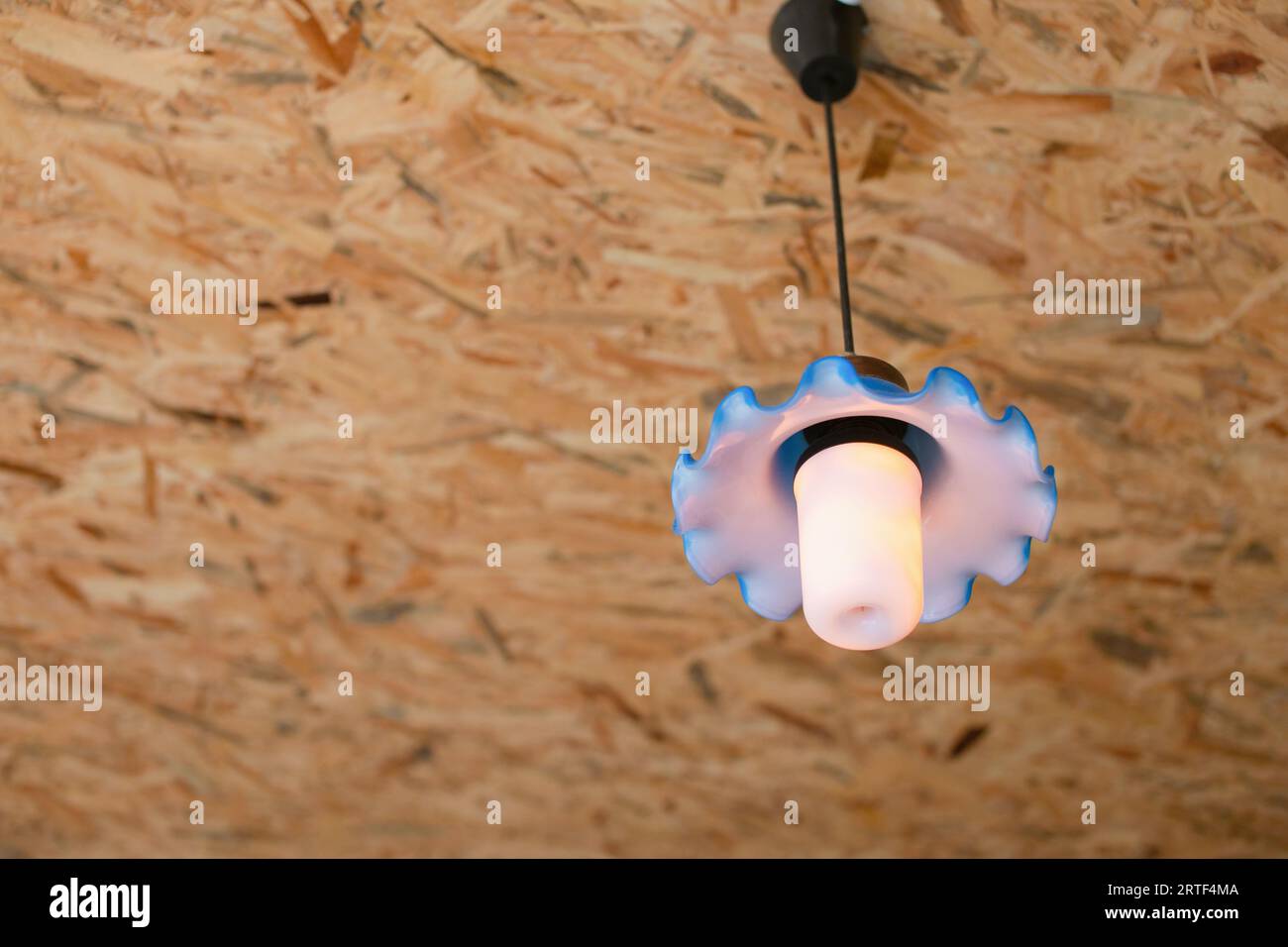 Orange ceiling lamp with wooden ceiling background Stock Photo - Alamy