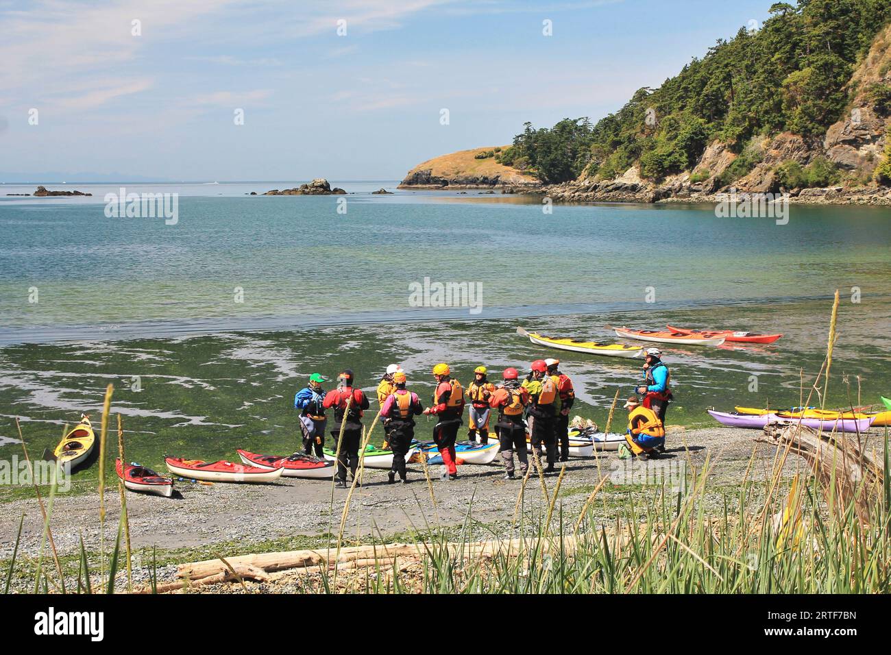 Experienced kayakers gather on a gently sloping Puget Sound beach to ...