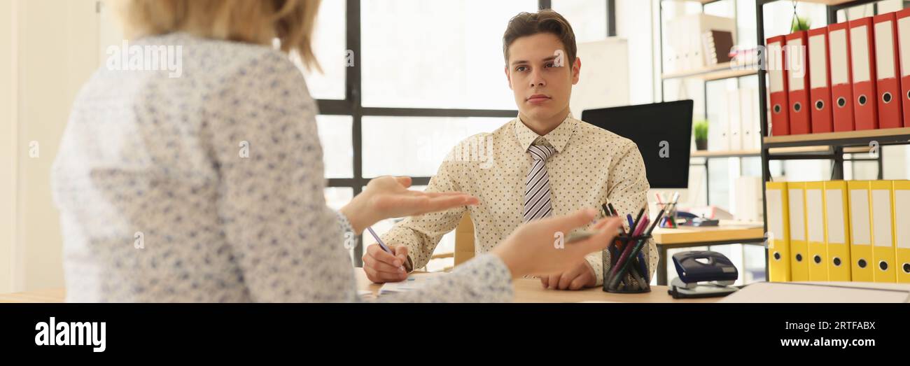 Male and female managers are talking to each other in workplace Stock ...