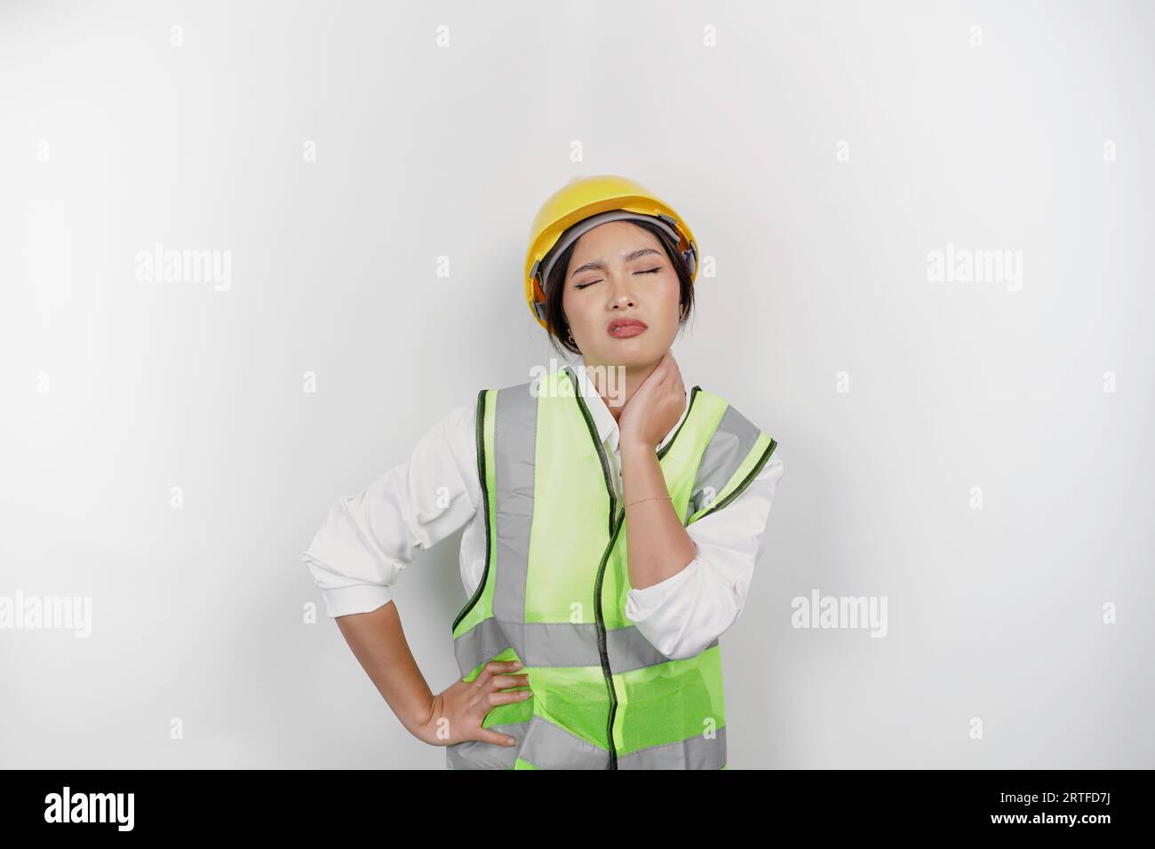 Tired Asian woman labor worker wearing a safety helmet and vest ...