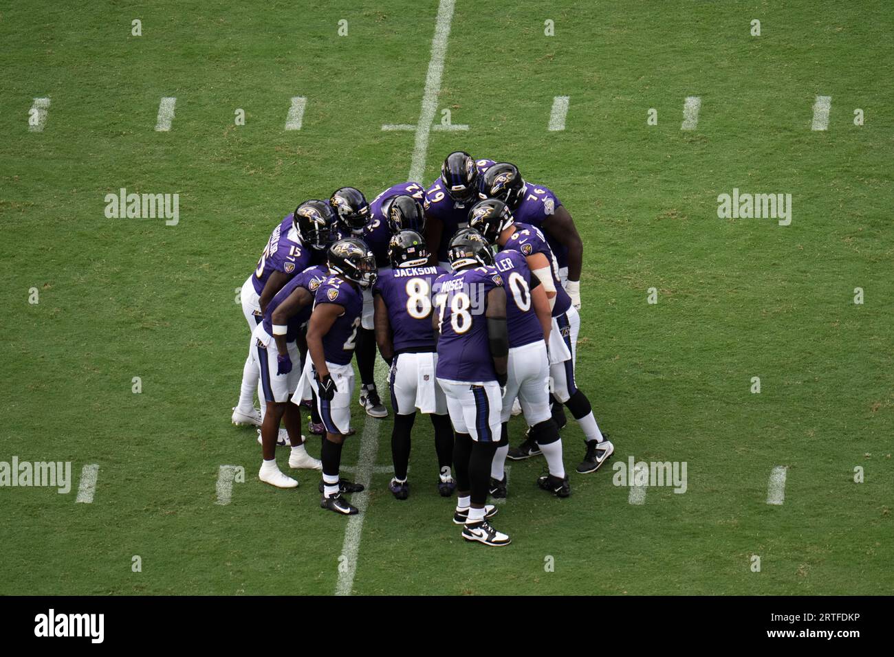Baltimore Ravens players huddle before a play during the second half of ...