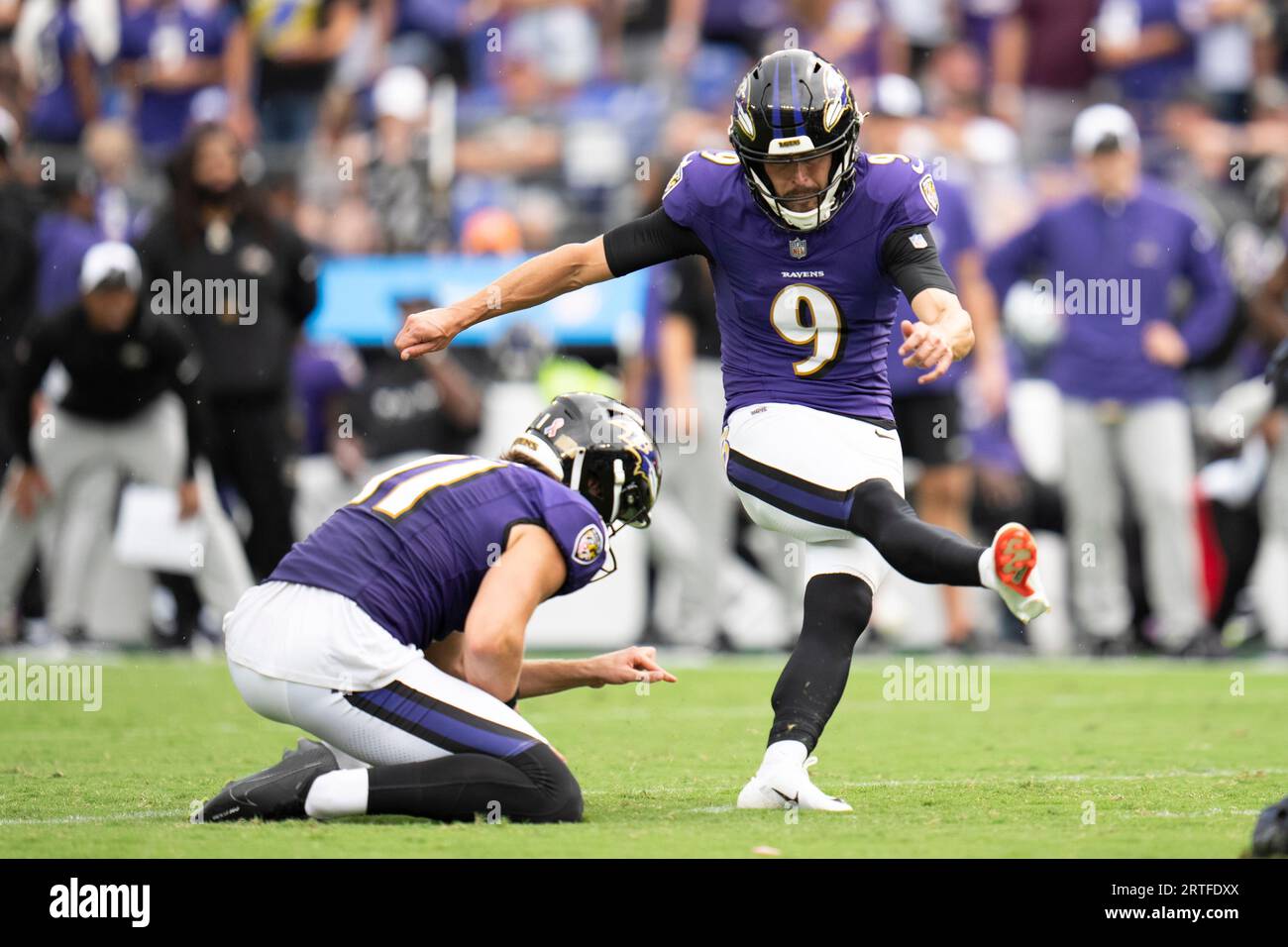 Baltimore Ravens kicker Justin Tucker (9), with Jordan Stout holding ...
