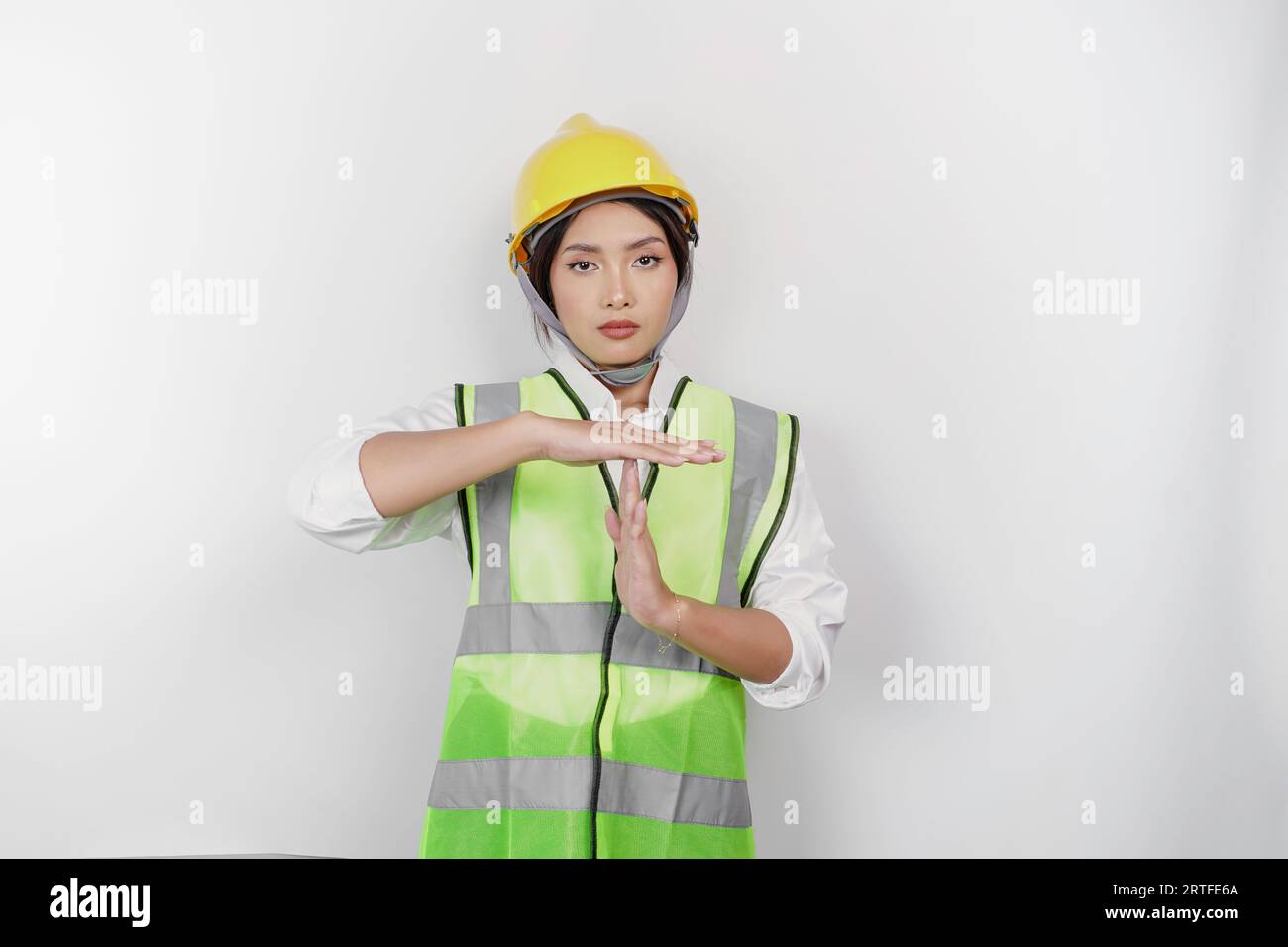 Hispanic woman labor wearing safety helmet and vest doing time out ...