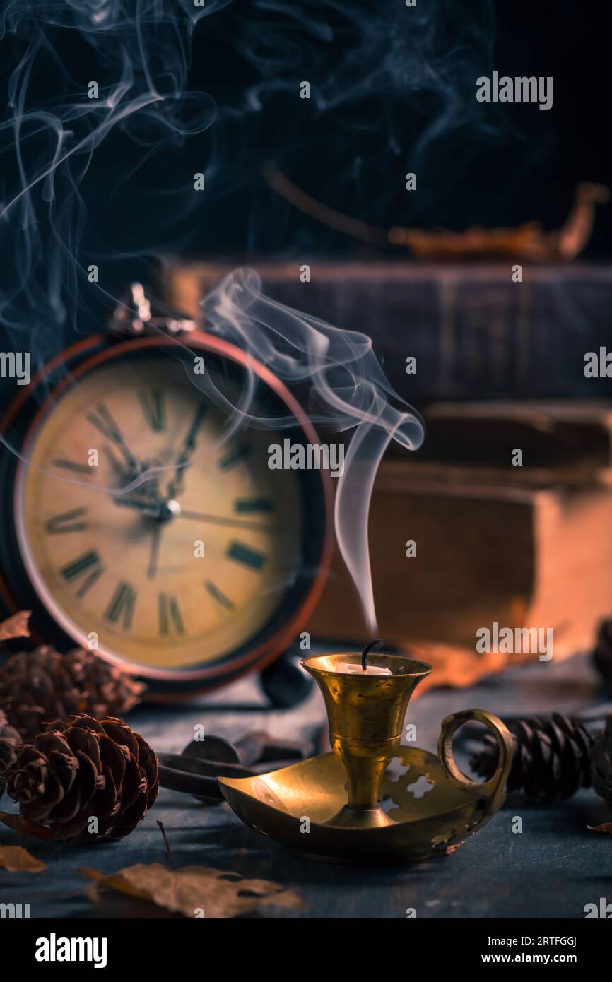 Vintage still life with antique books, clock and candle. Halloween and ...