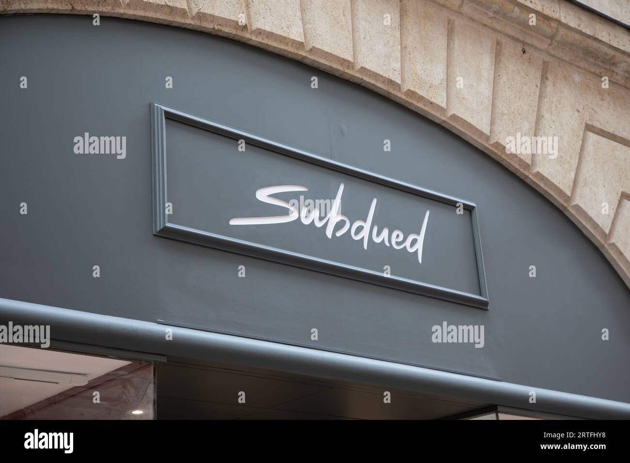 Milan , Italy - 09 01 2023 : Subdued logo brand and text sign on facade ...