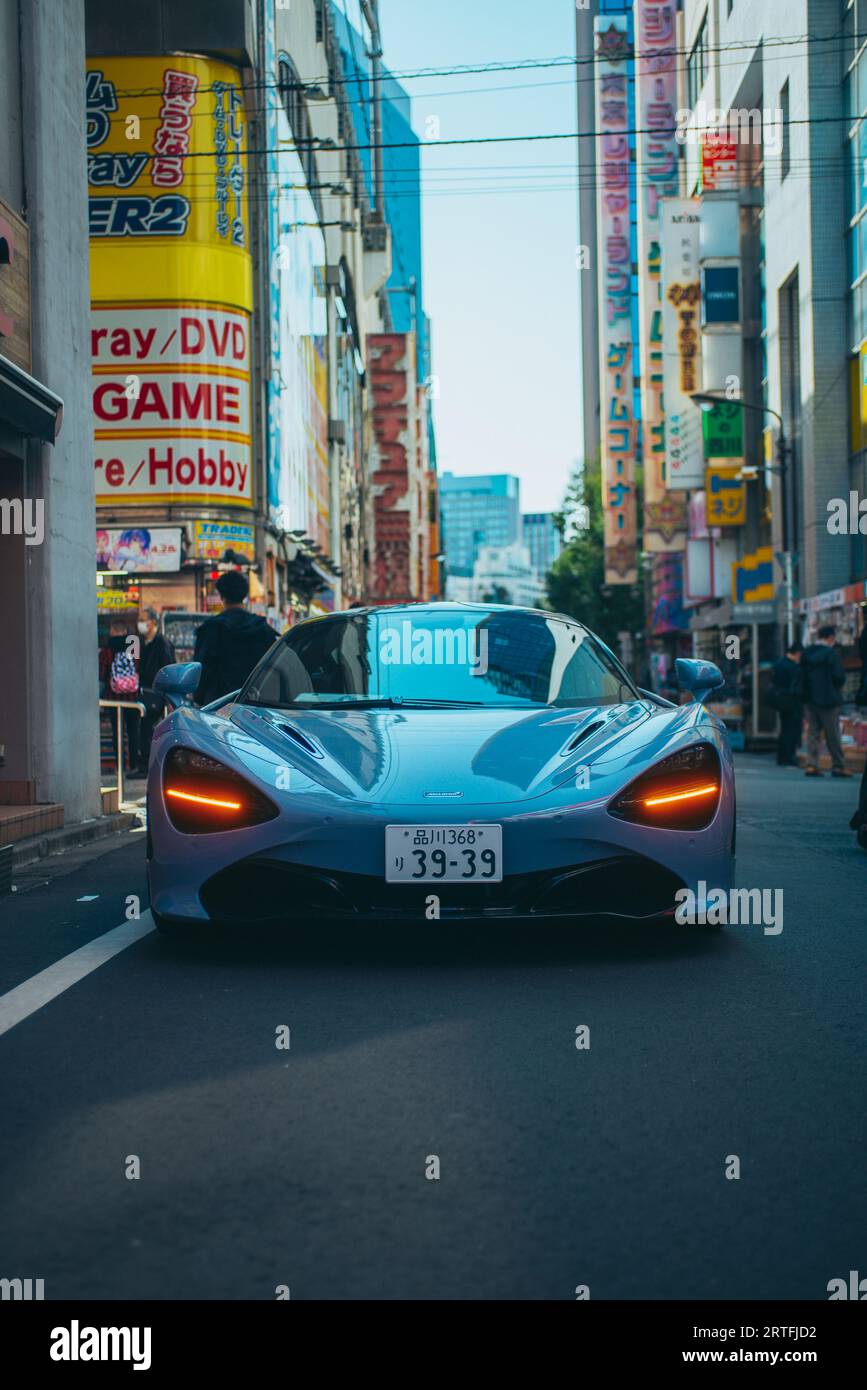 A vertical of a sleek blue car on the streets of Tokyo, Japan Stock ...