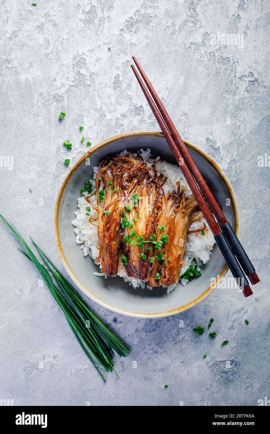 Rice with enoki mushrooms and chives. Asian vegan diet meal Stock Photo ...