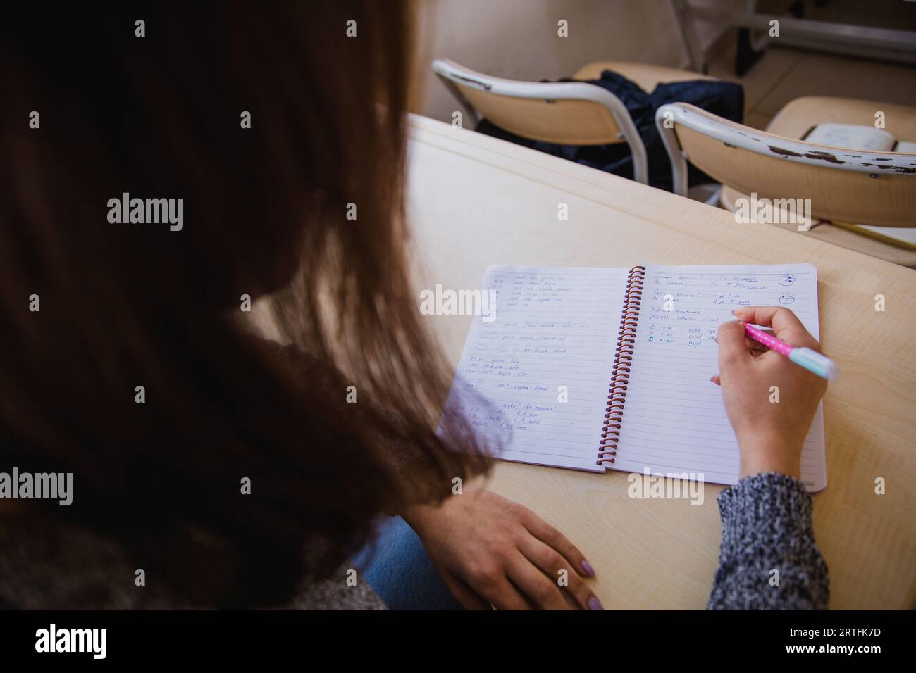 girl alone in classroom, making notes in turkish Stock Photo - Alamy