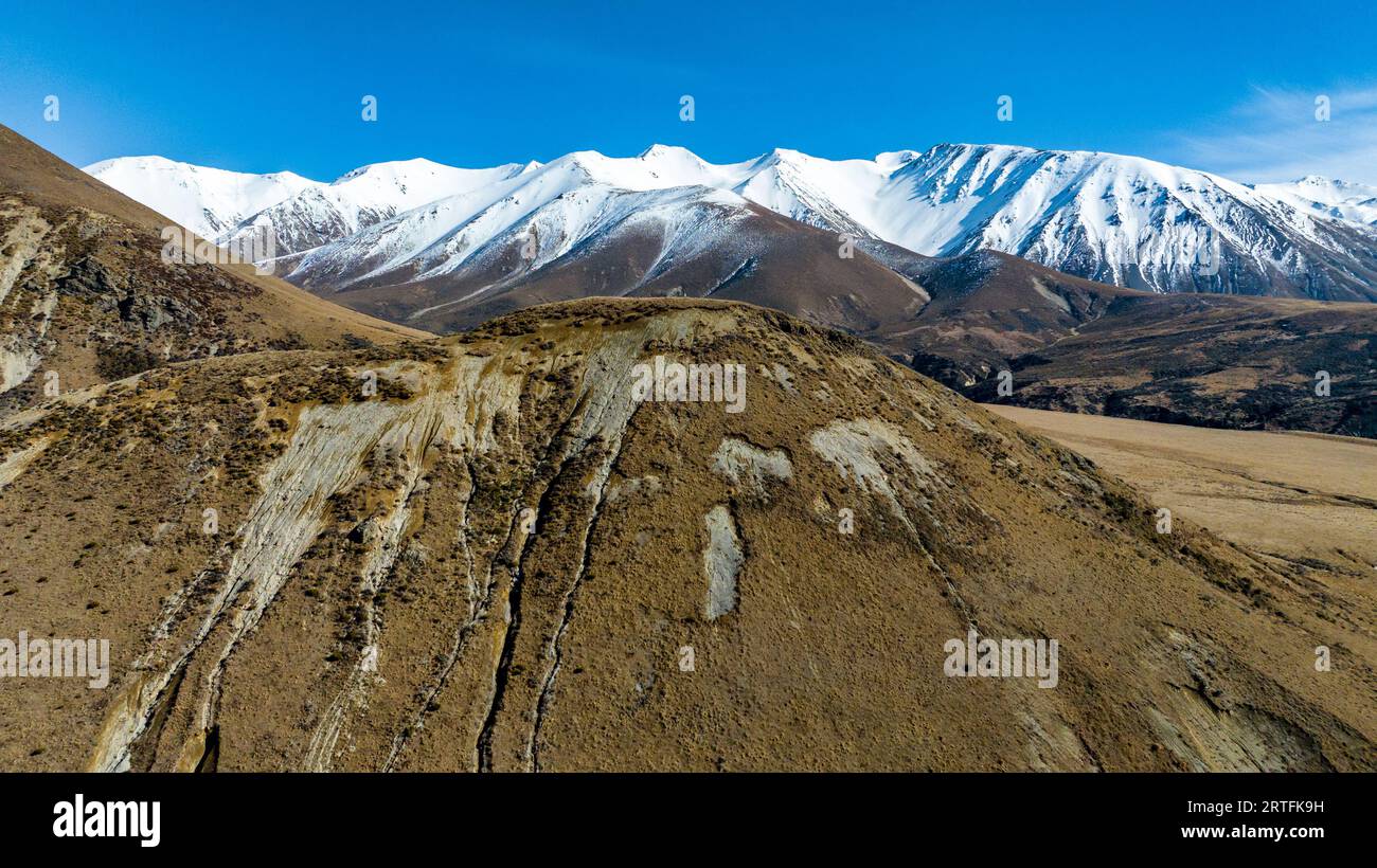 Snow capped mountains and lower hills with an arid valley in between ...