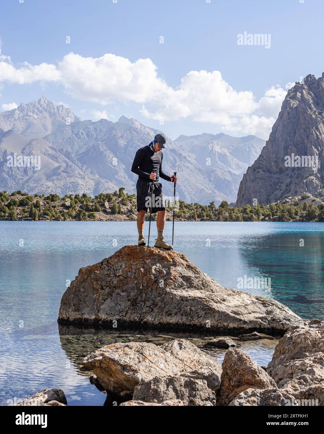 Man hiker exploring mountains lake in Tajikistan Stock Photo - Alamy