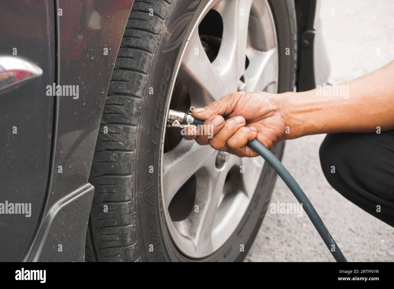 Klaten, Indonesia - August 17 2023: man driver hand inflating tires of ...
