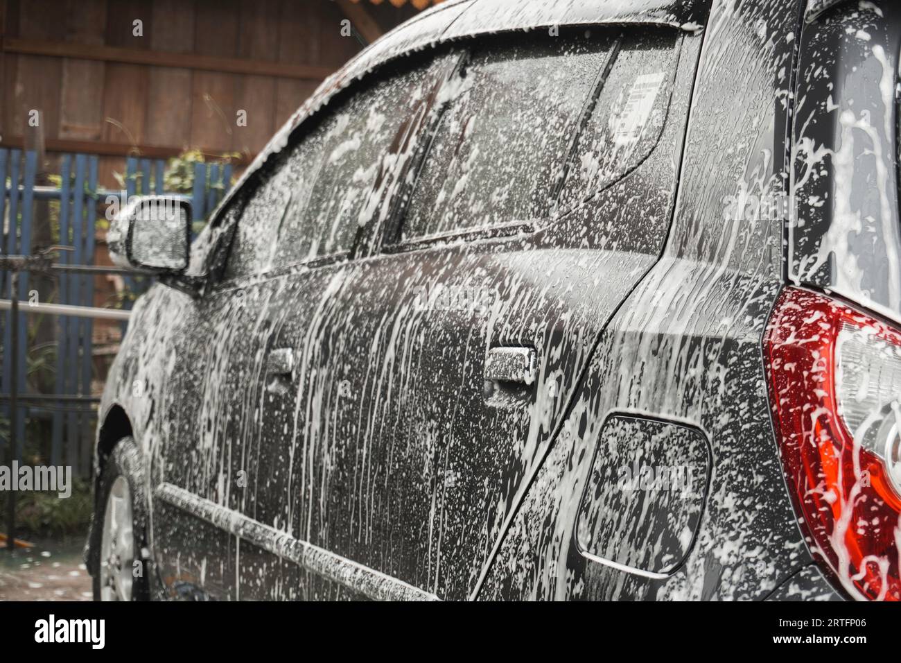 Klaten, Indonesia - August 17 2023: A grey car is being wash in a self ...