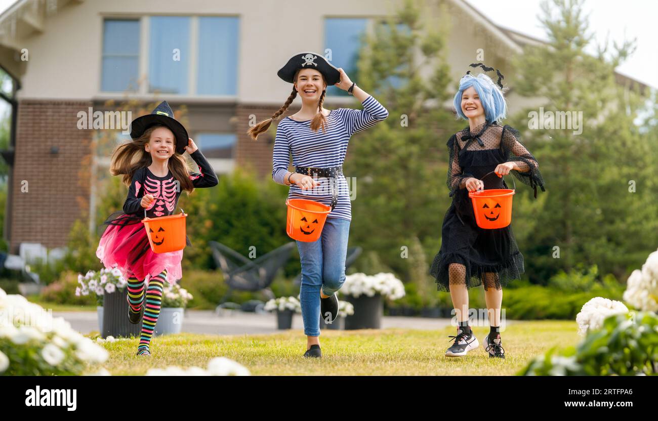 Happy kids at Halloween party. Children are wearing carnival costumes ...
