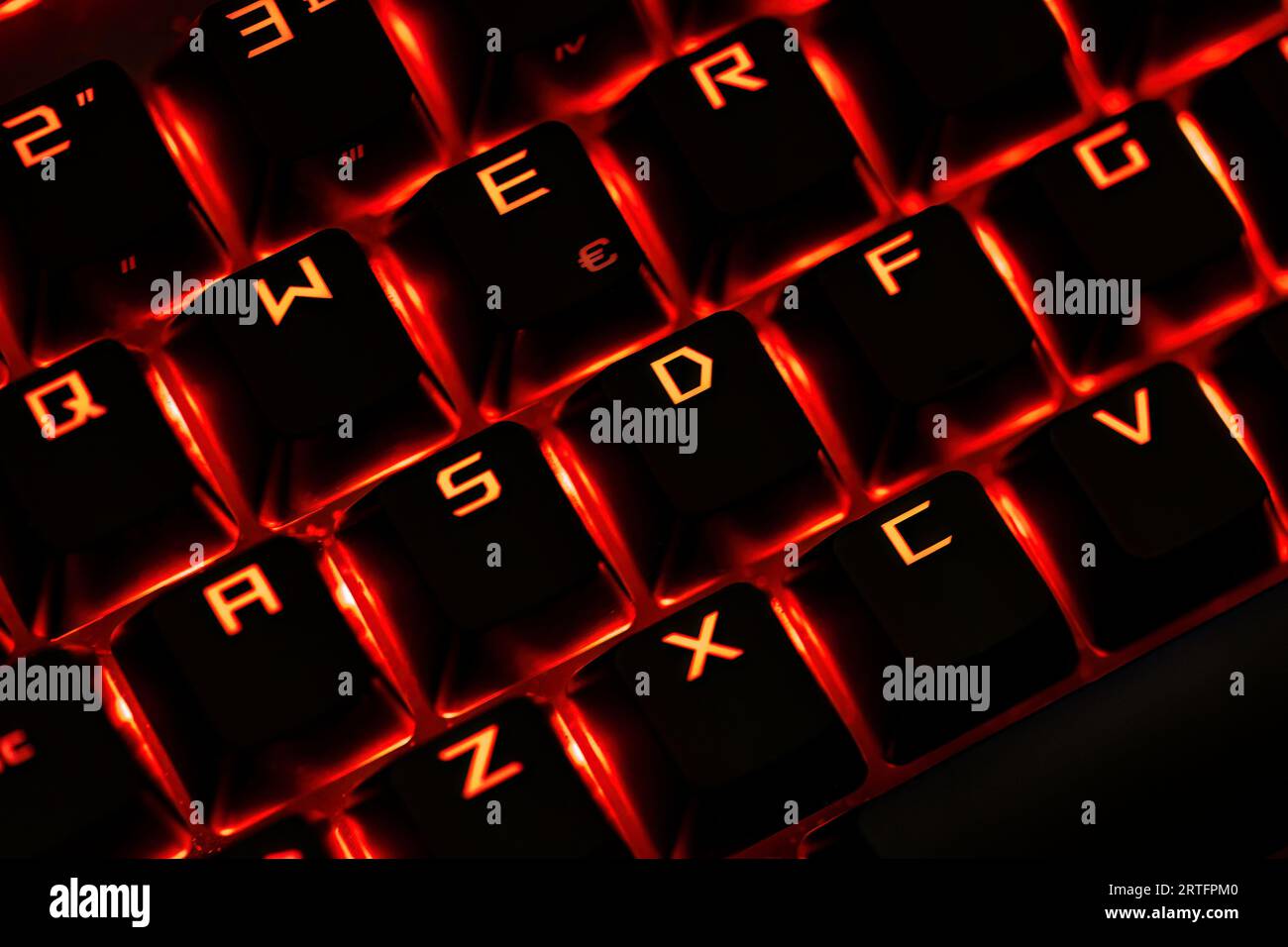 Close-up of a gaming keyboard with illuminated backlit keys ...