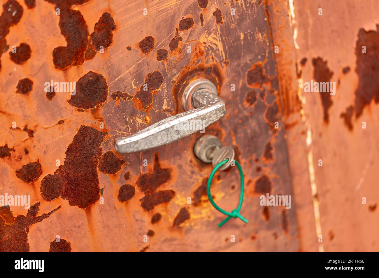Close-up view of a corroded metal door handle revealing oxidation and ...