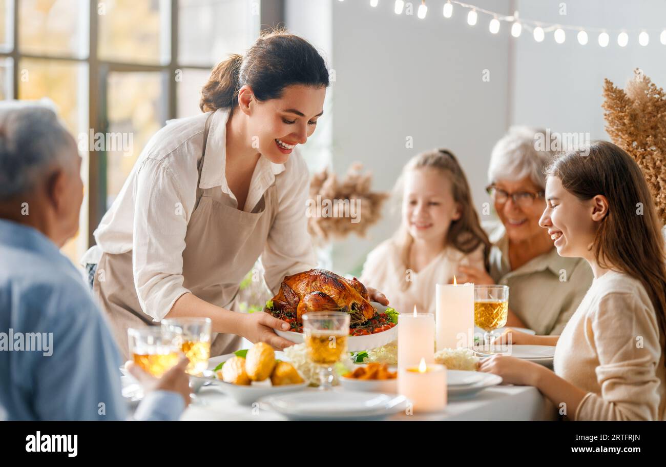 Thanksgiving Day, Autumn feast. Happy family sitting at the table and ...