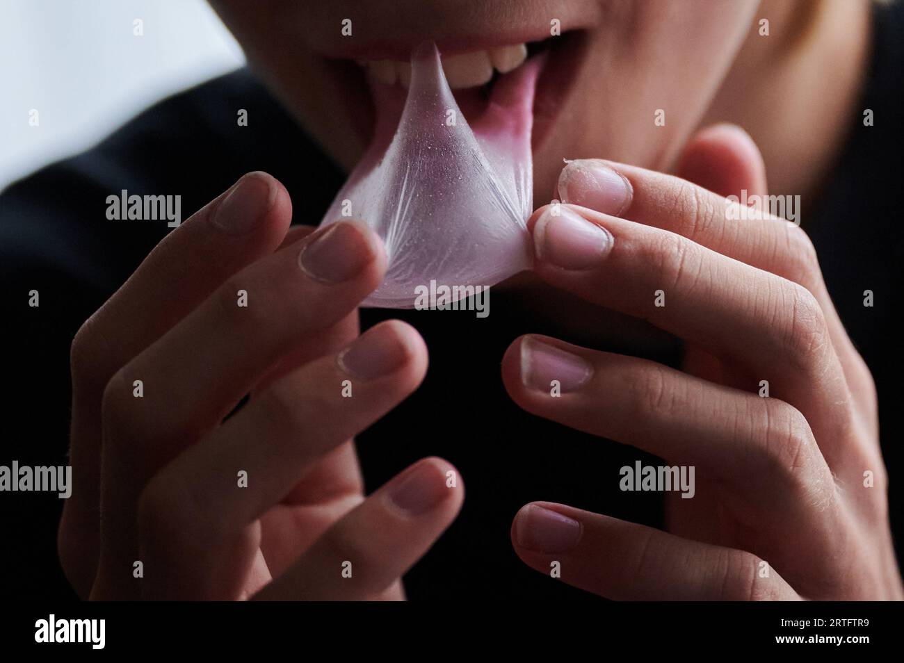 Berlin, Germany. 27th Aug, 2023. A child takes a sticky gum out of his ...