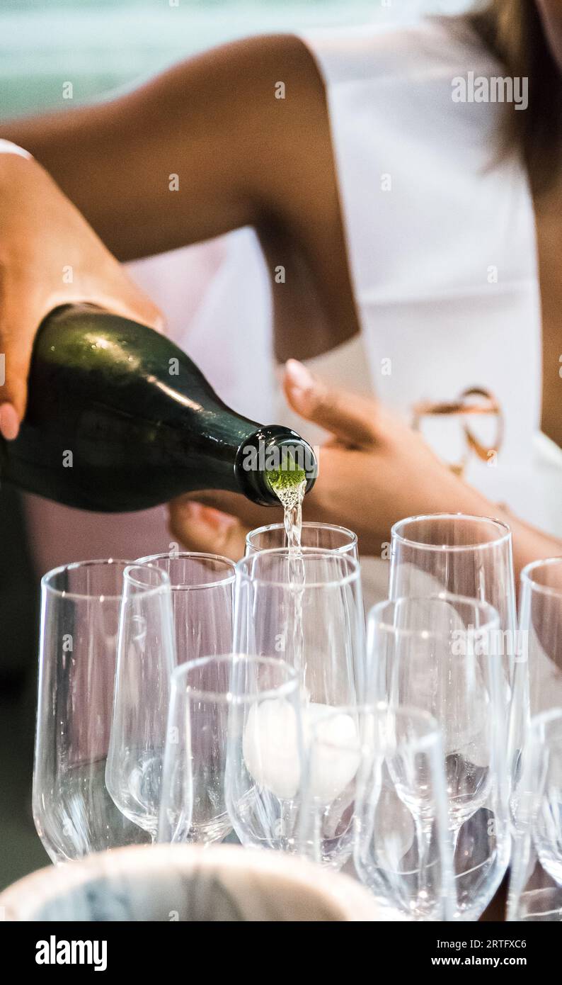 Bachelorette party, bride serving champagne over table in tall ...