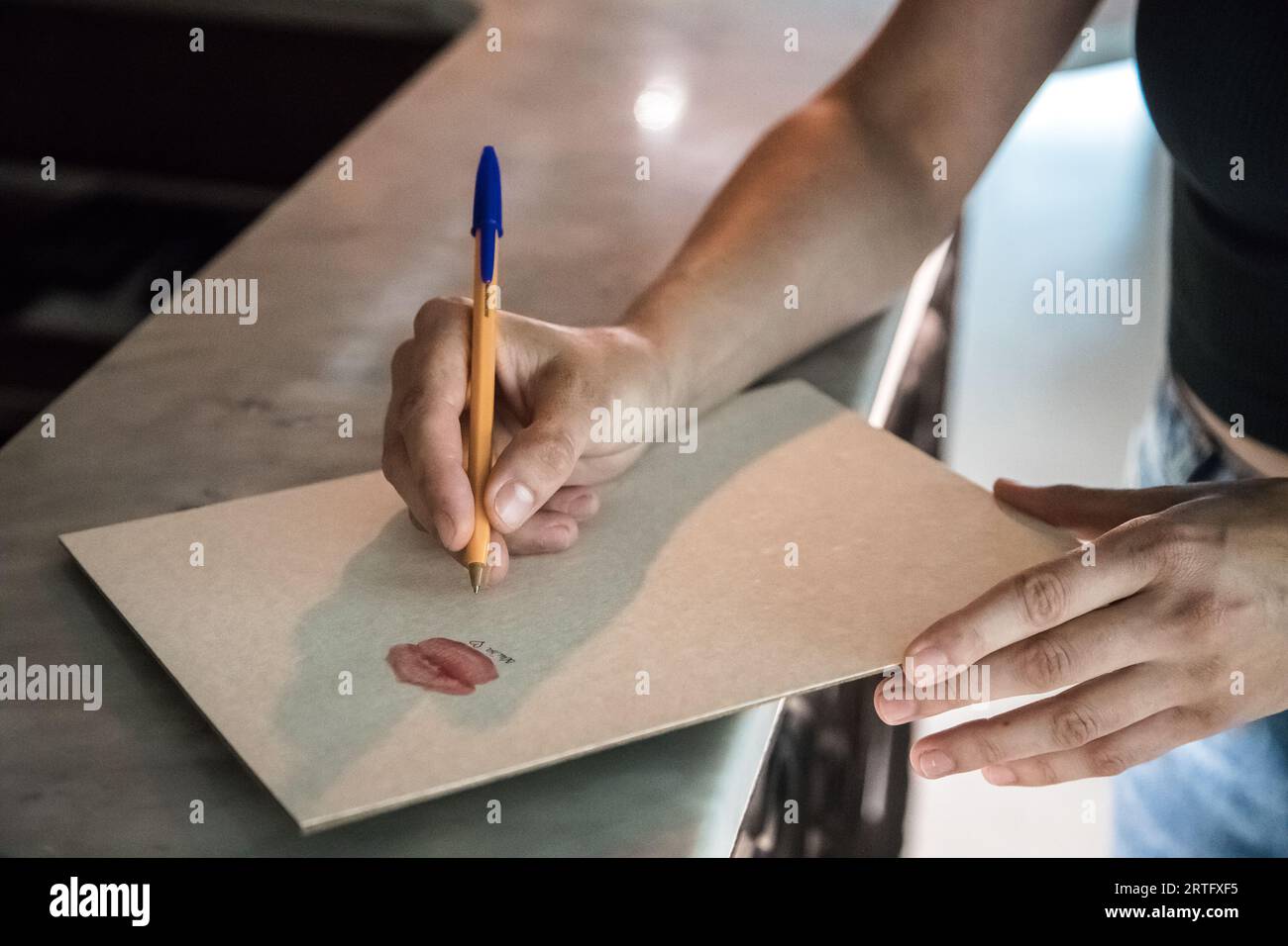 Person writing on a paper. Bachelorette party. Woman writing on paper ...
