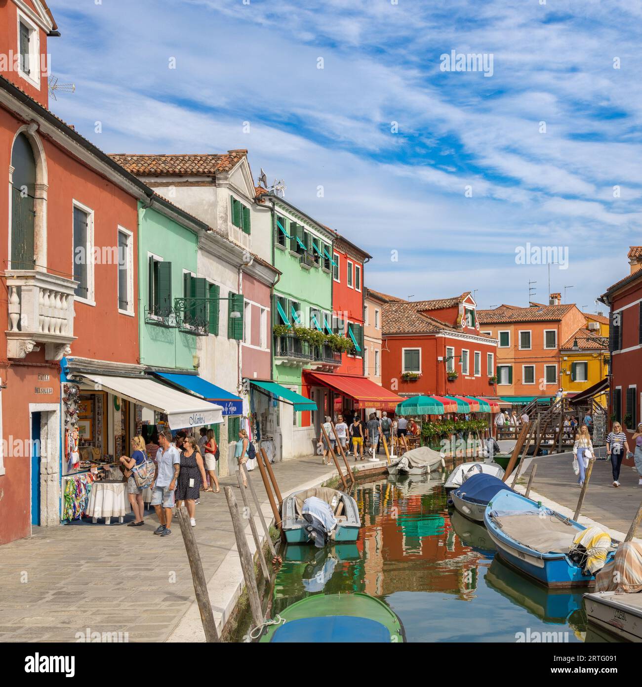 Burano, Italy - August 9, 2023; View of colorful Venetian houses along the canal at the Islands ...