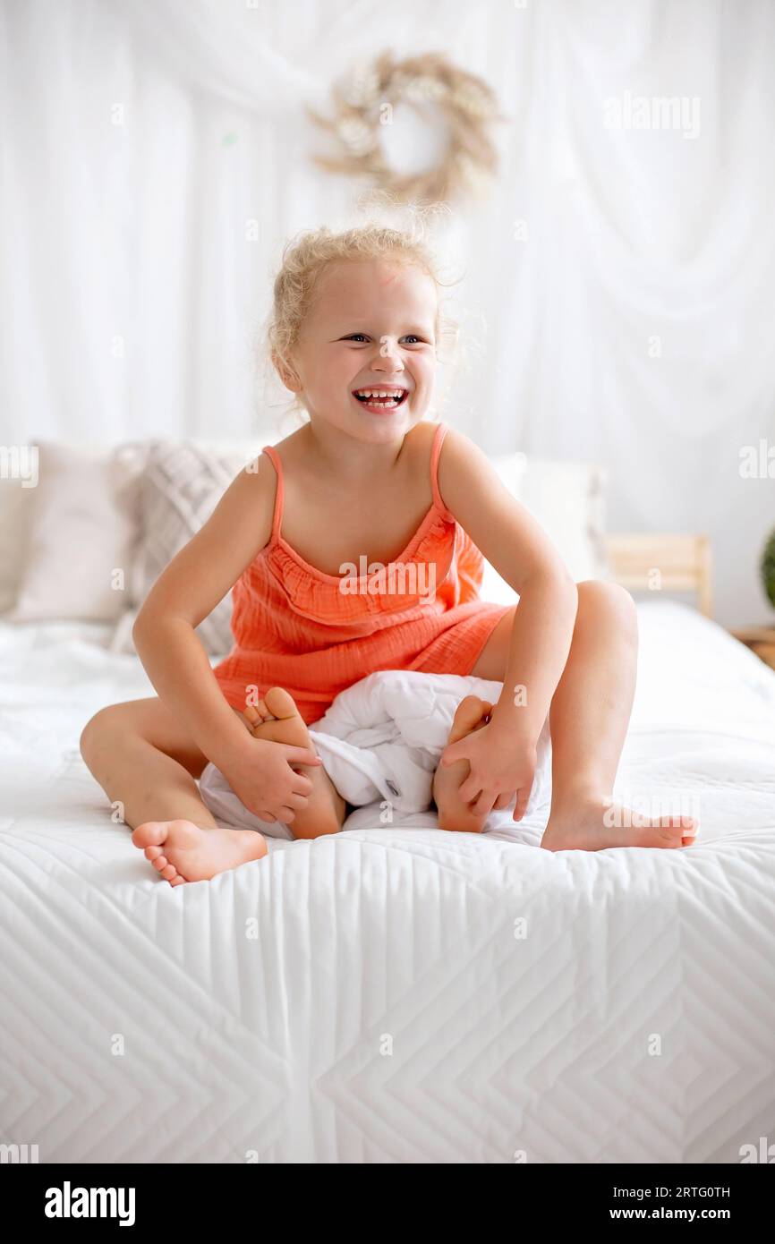 Happy positive children, tickling on the feet, having fun together, boy ...